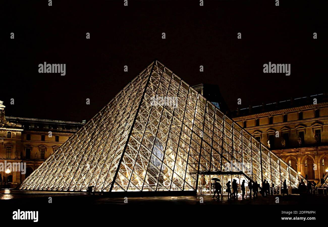 Louvre Museum pyramid in Paris illuminated in the evening with visitors ...