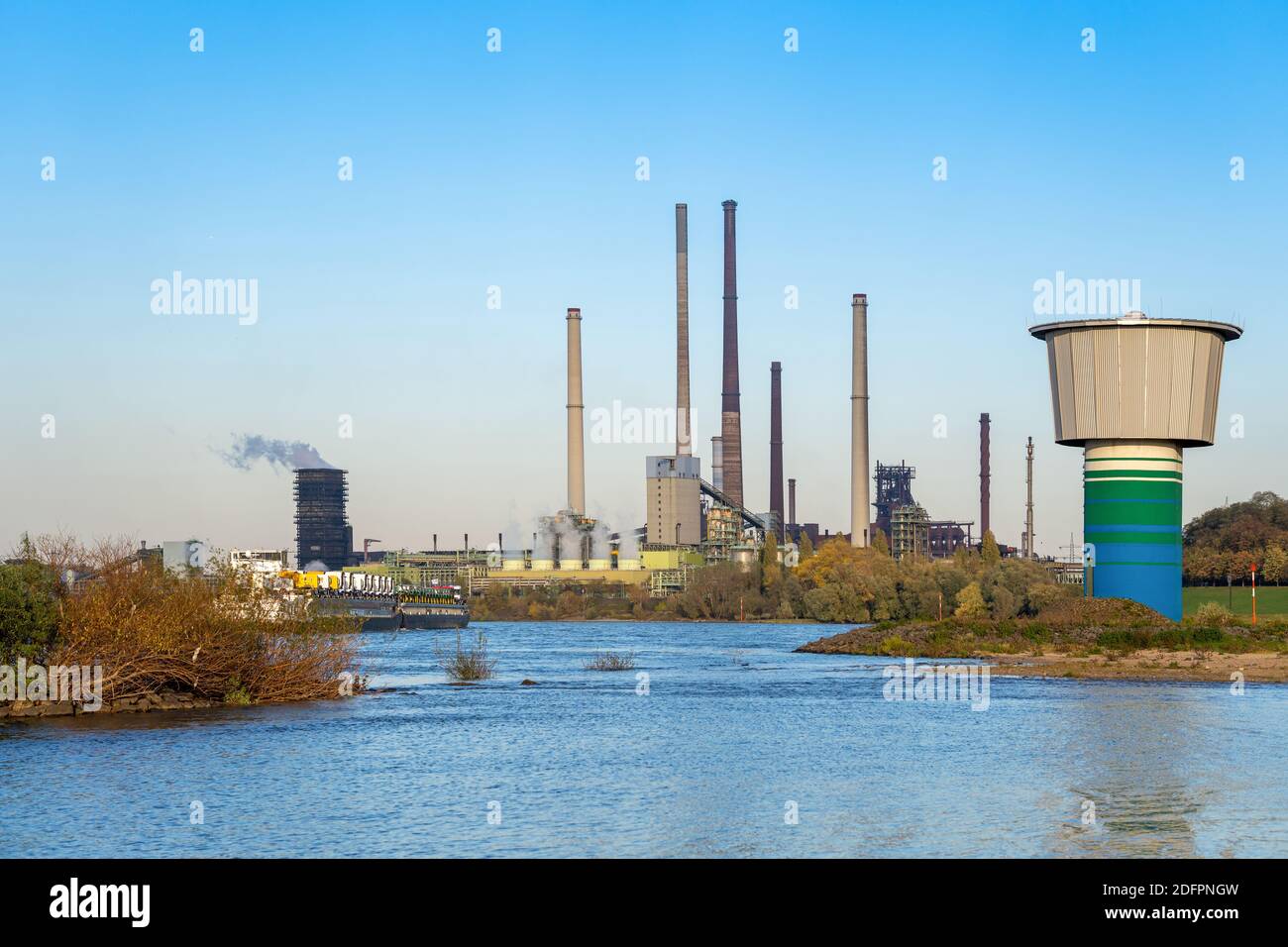 A river flowing next to a power station Stock Photo - Alamy