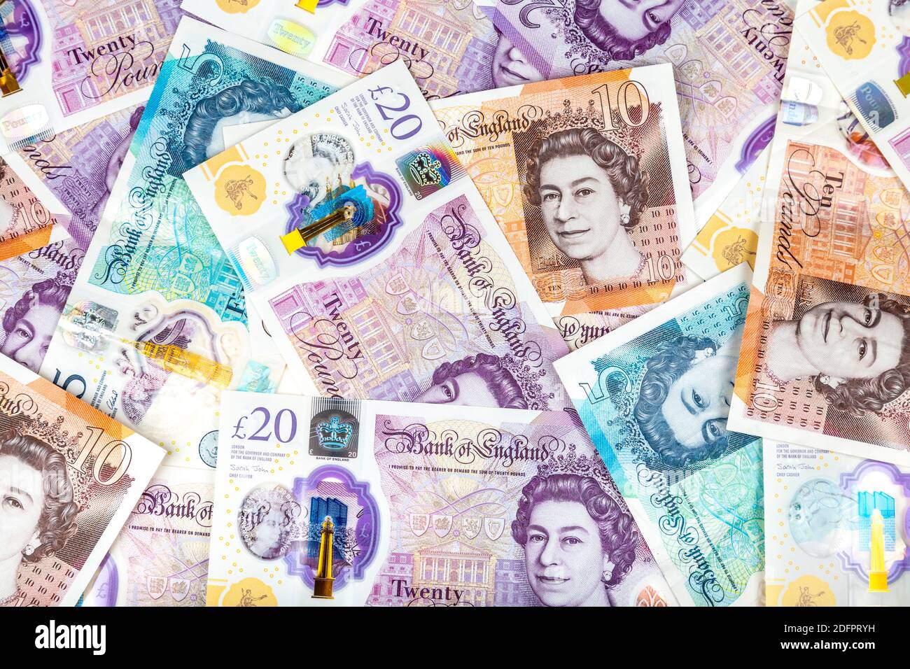 New British pound polymer notes scattered Stock Photo - Alamy