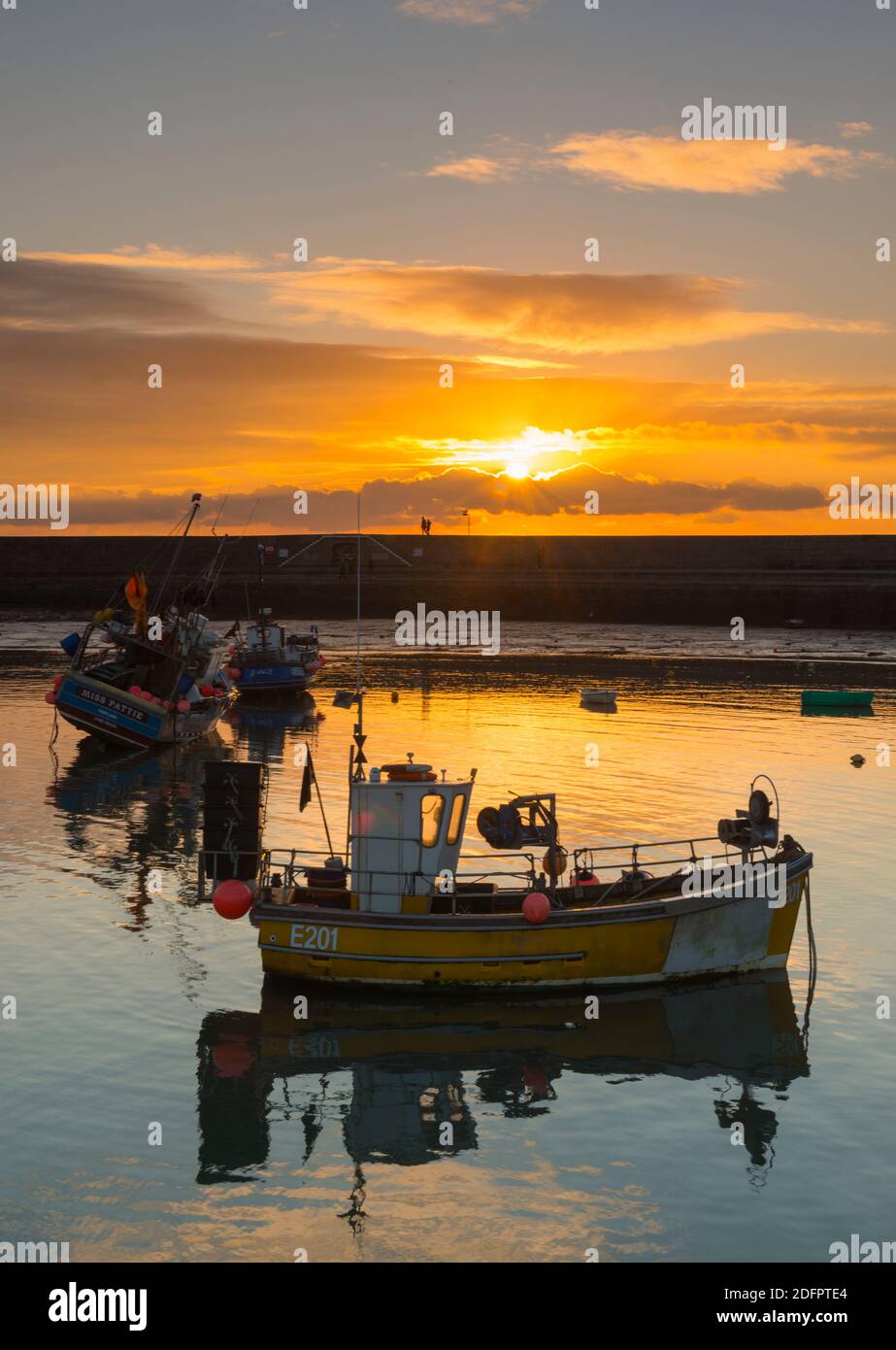 Lyme Regis, Dorset, UK. 6th December 2020. UK Weather. The sky glows ...