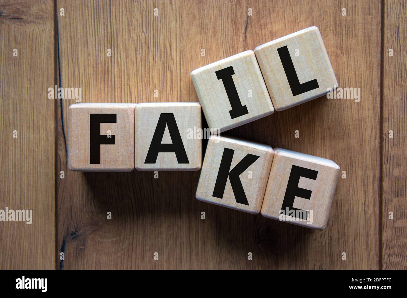 Fail fake symbol. Wooden cubes with words 'fail fake' on beautiful ...