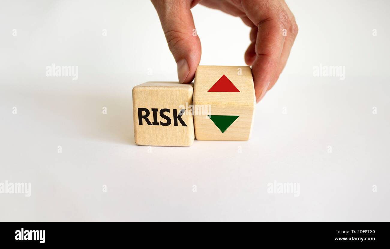 Risk symbol. Wooden cube with word 'risk'. Male hand turns the wooden ... Risk symbol. Wooden cube with word 'risk'. Male hand turns the wooden ...