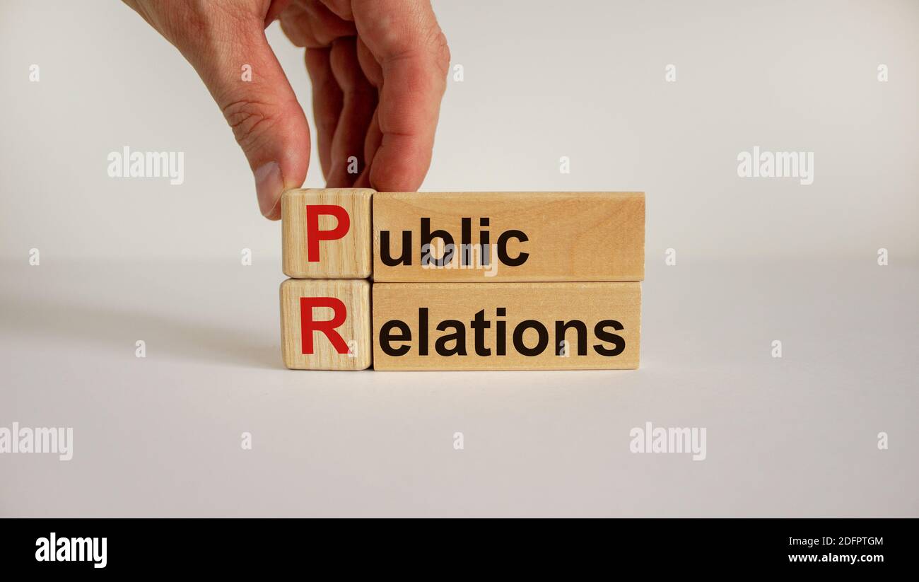 PR symbol. Wood cubes and blocks with words 'PR, public relations' on ...