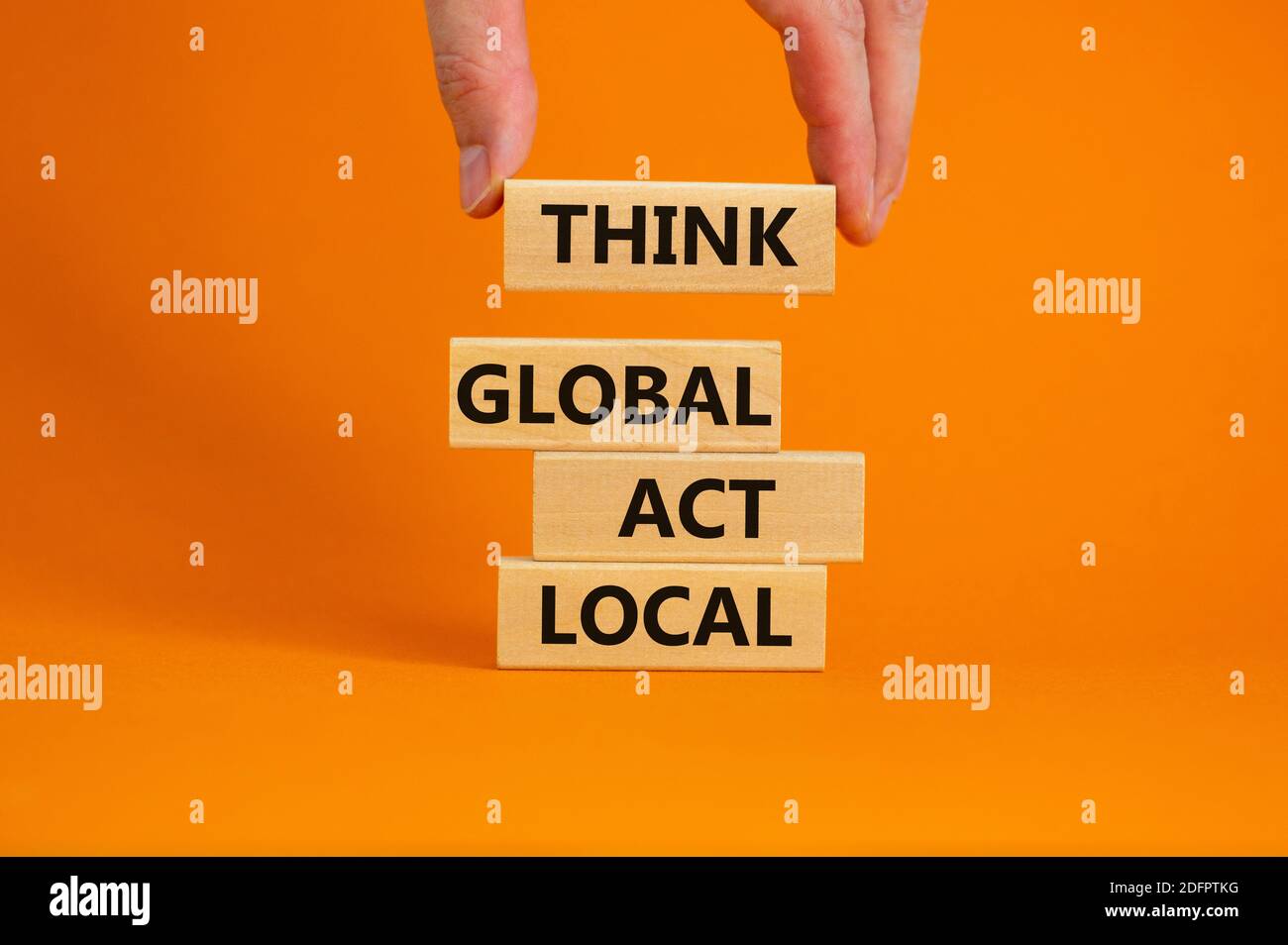 Think global act local symbol. Wooden blocks form the words 'Think ...
