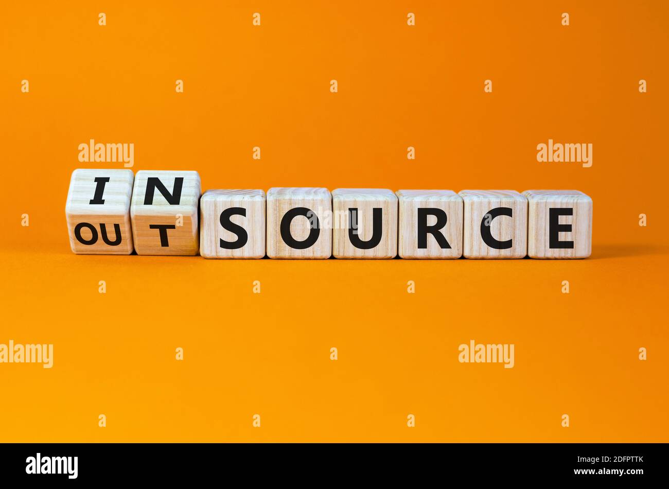Outsource or insource symbol. Fliped wooden cubes and changed the word ...
