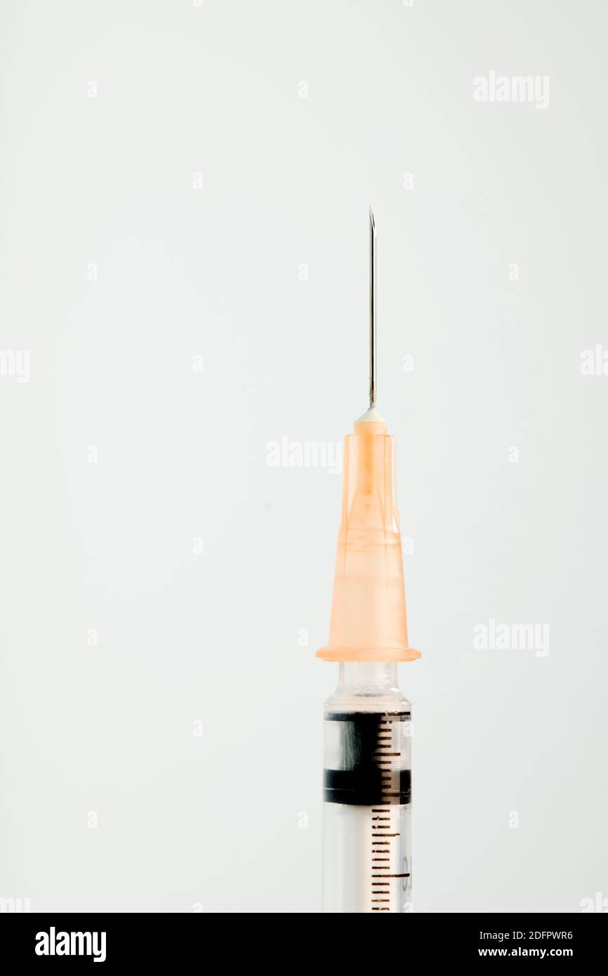 vaccination syringe, with orange cannula and white background Stock ...