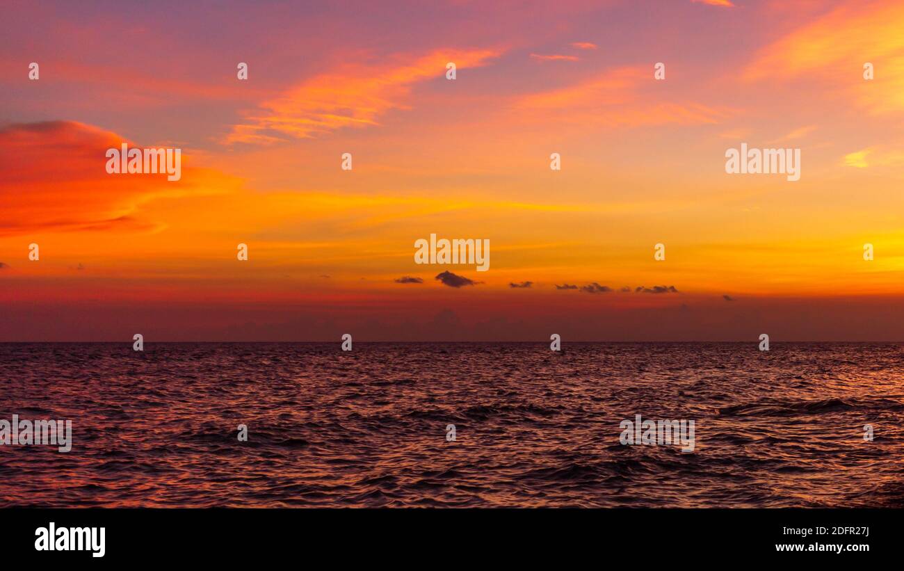 Beautiful sky colors after sunset time, shiny sea water waves, orange ...