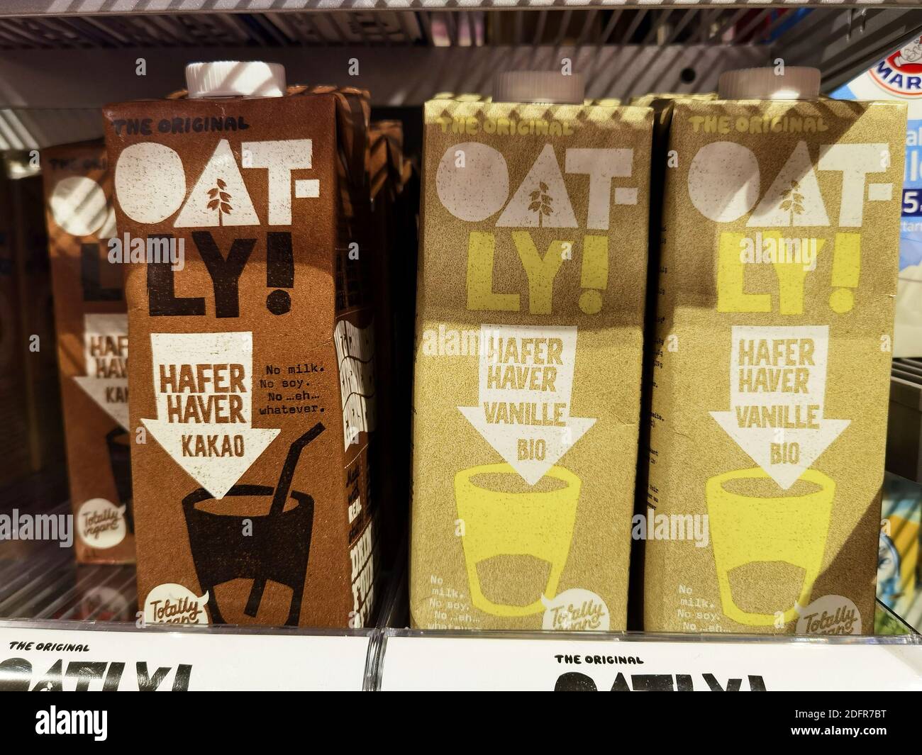 Berlin, Germany - December 1, 2020: View to a shelf with different milk ...