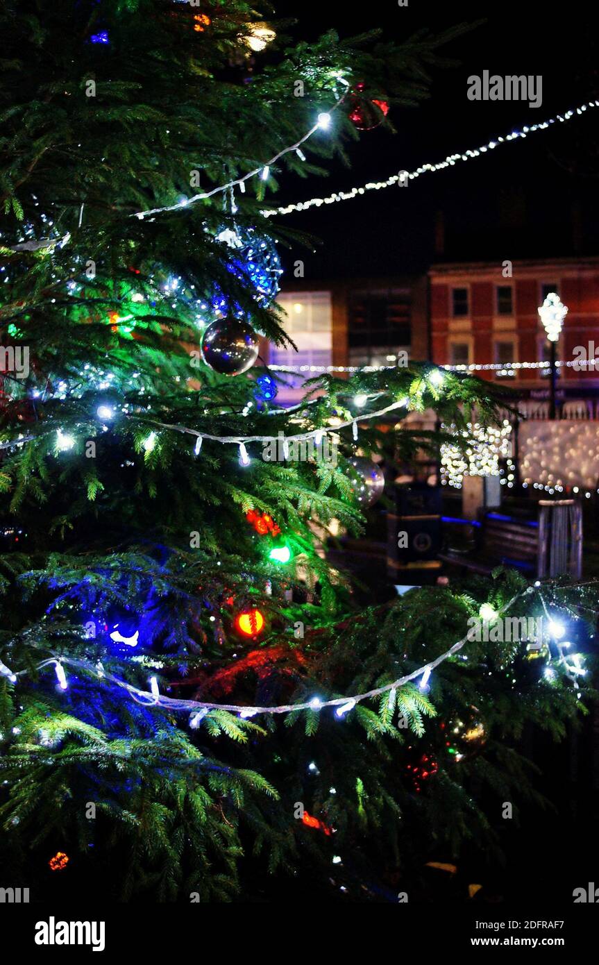 Closeup of a Christmas tree with lights at night in a town centre Stock ...