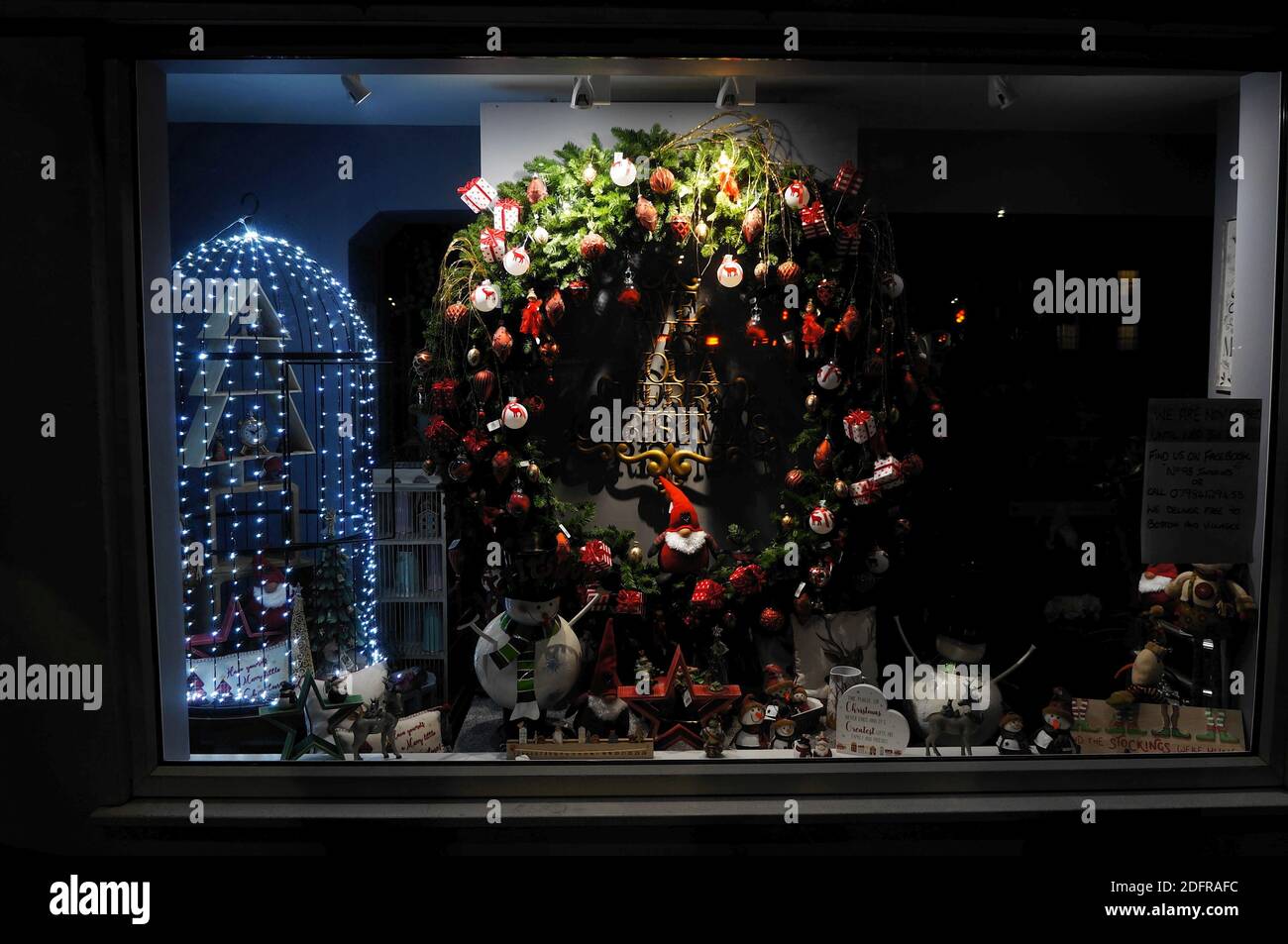a festive display in an illuminated shop window at night Stock Photo ...