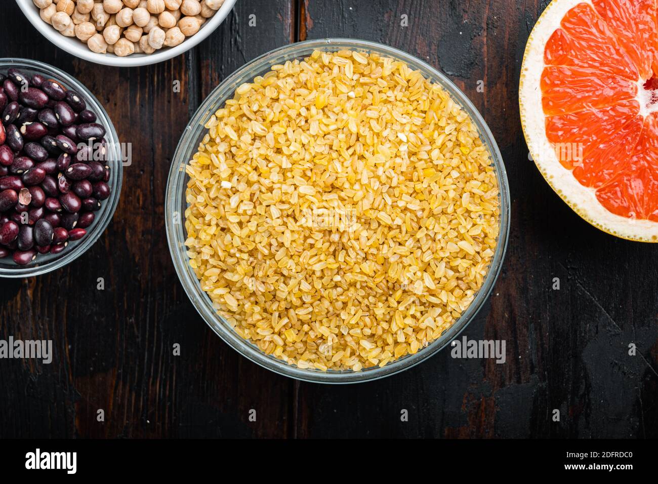 Bulgur grain in bowl, top view on dark wooden background Stock Photo ...