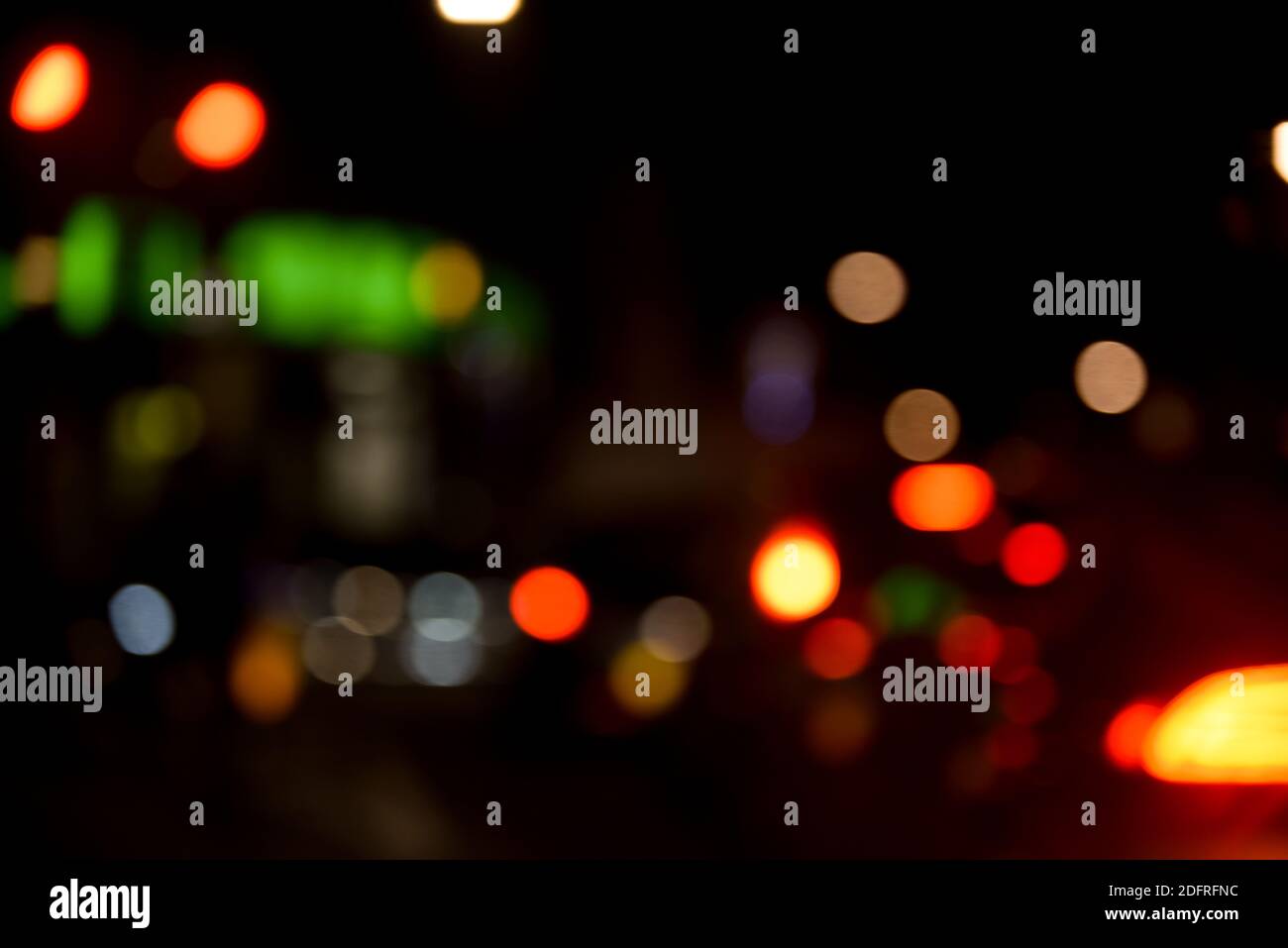 Blurred view of urban city street in busy area with traffic and shops ...