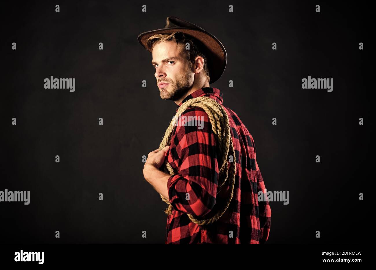 Western life. Man wearing hat hold rope. Lasso tool of American cowboy ...