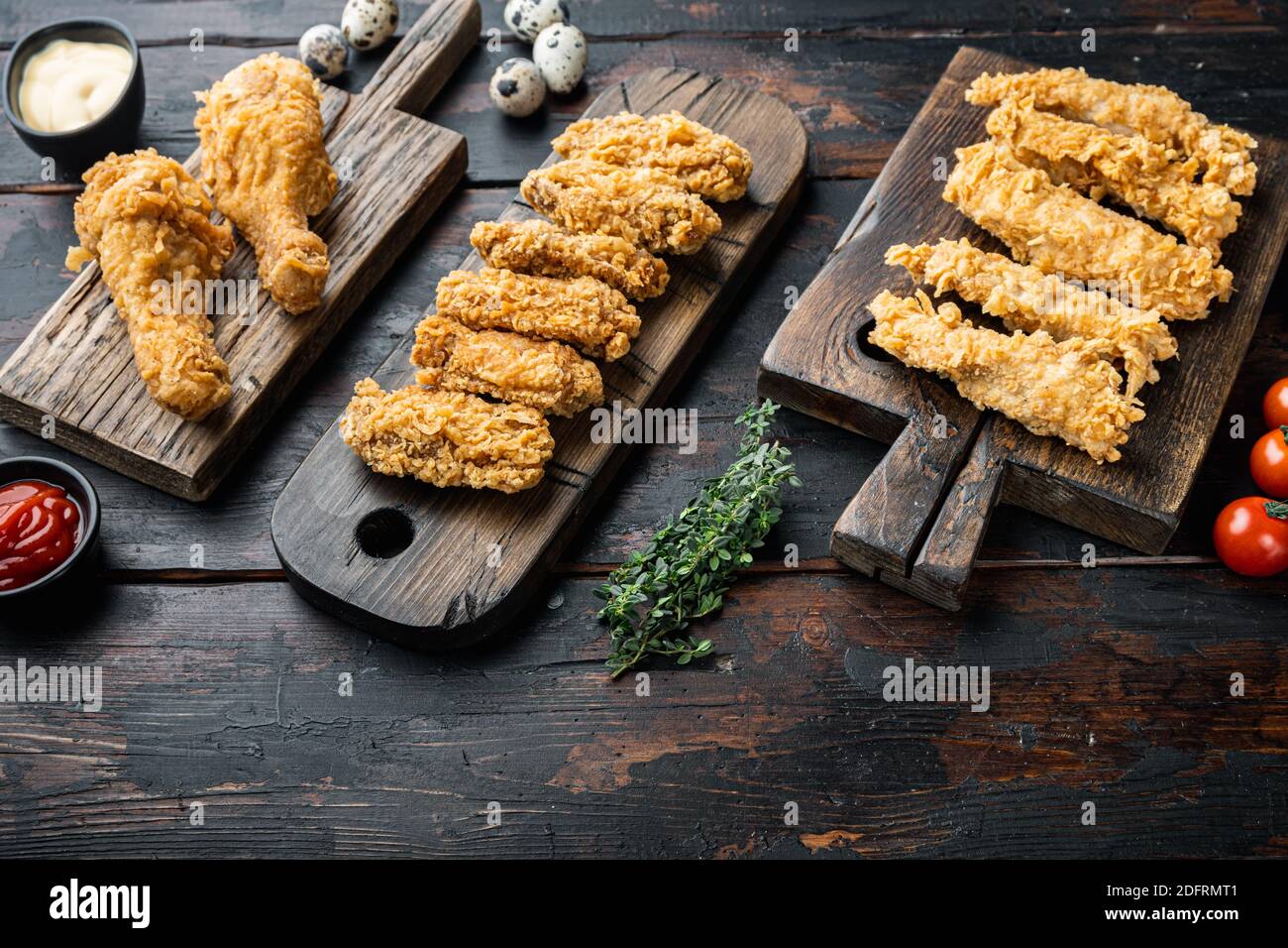 Breaded fried chicken parts on dark wooden background Stock Photo - Alamy