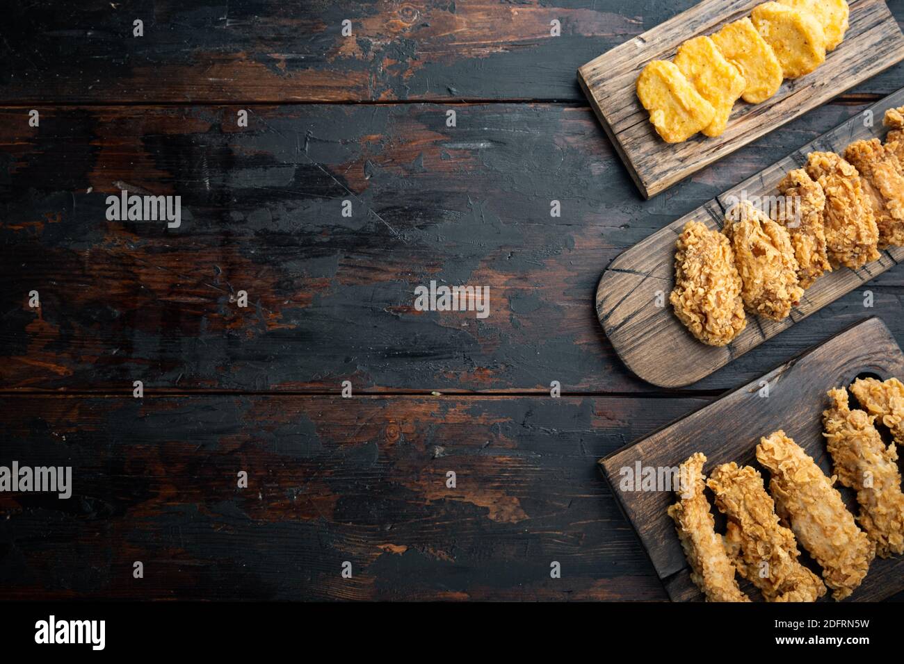 Crispy kentucky fried chicken cuts on dark wooden background, top view ...