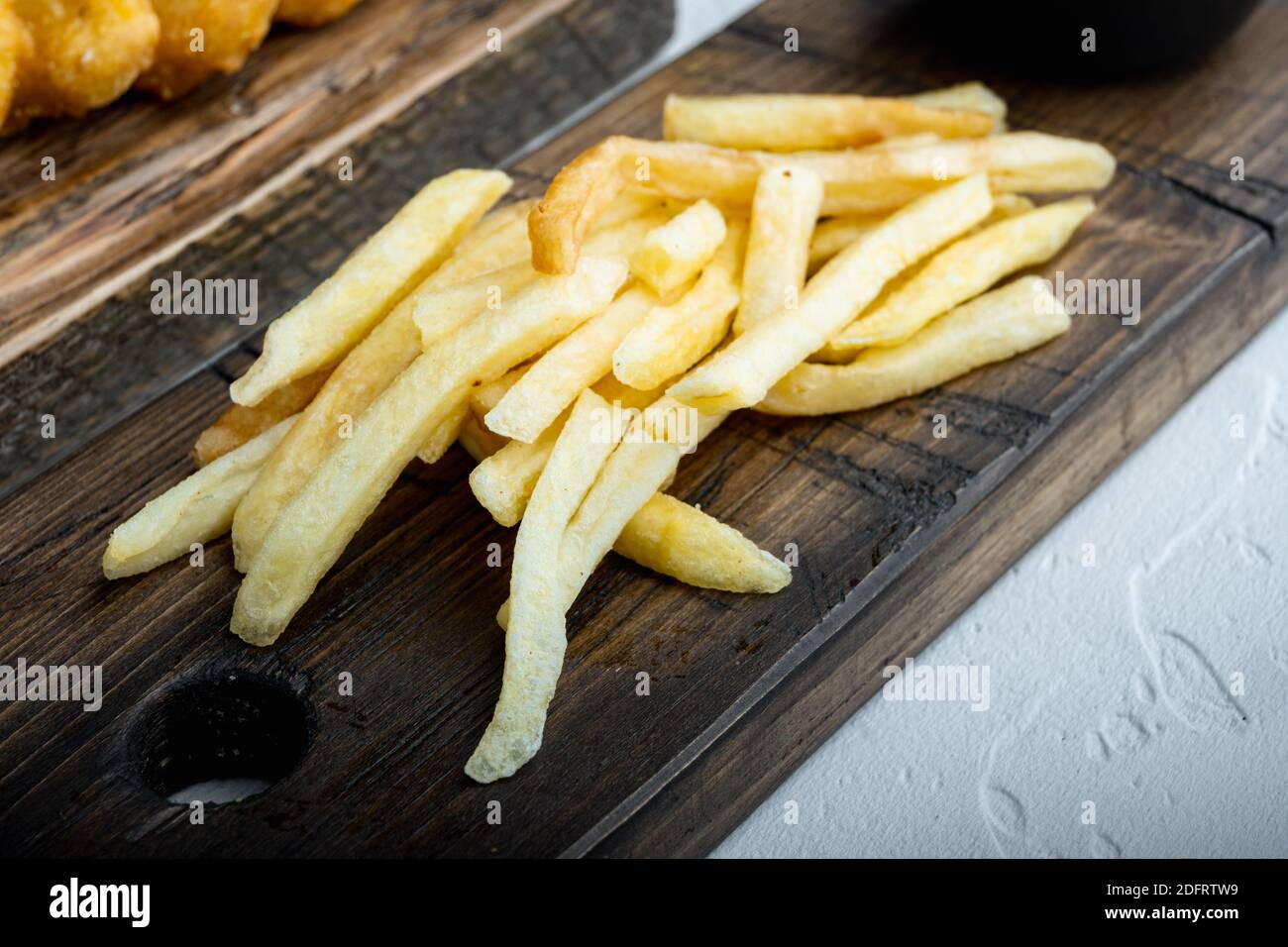 French fries fried on white background Stock Photo - Alamy