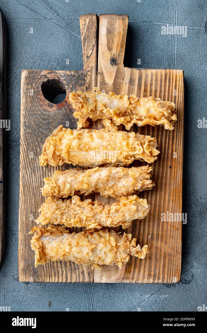 Crispy chicken tenders cuts on grey background Stock Photo - Alamy