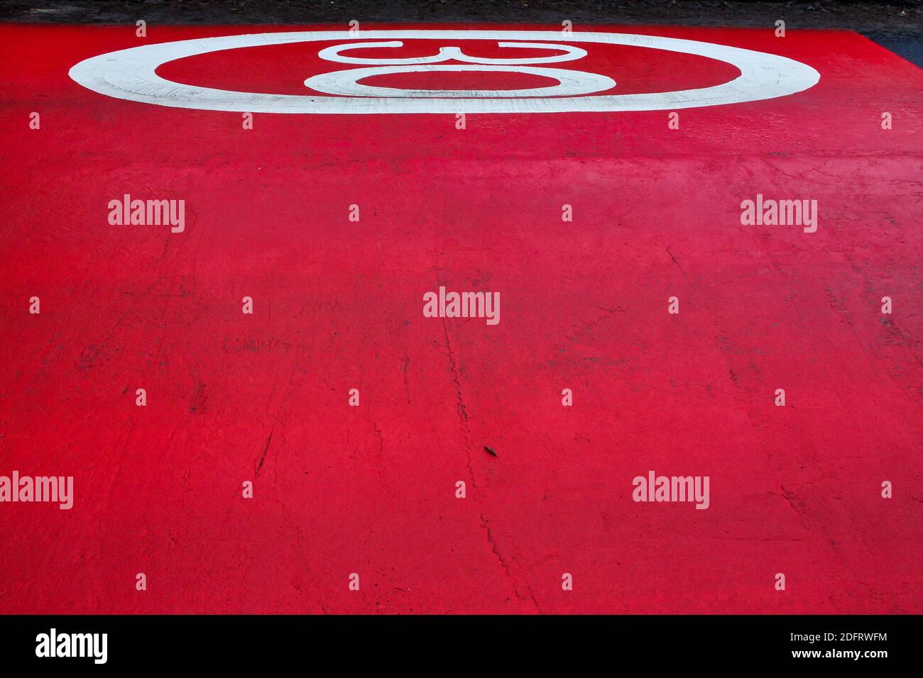Bright red speed sign on the surface of a road in Scotland Stock Photo ...