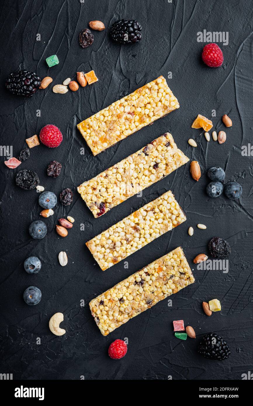Fruit berry, nut energy bars. Healthy snack, top view, on black ...