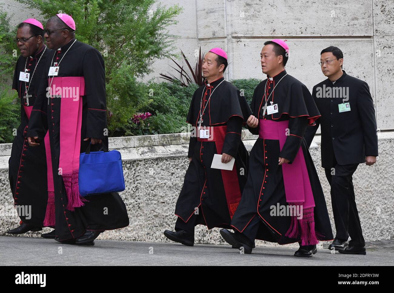 Chinese bishops Guo Jincai and Yang Xiaoting arrive at the Synod Hall ...