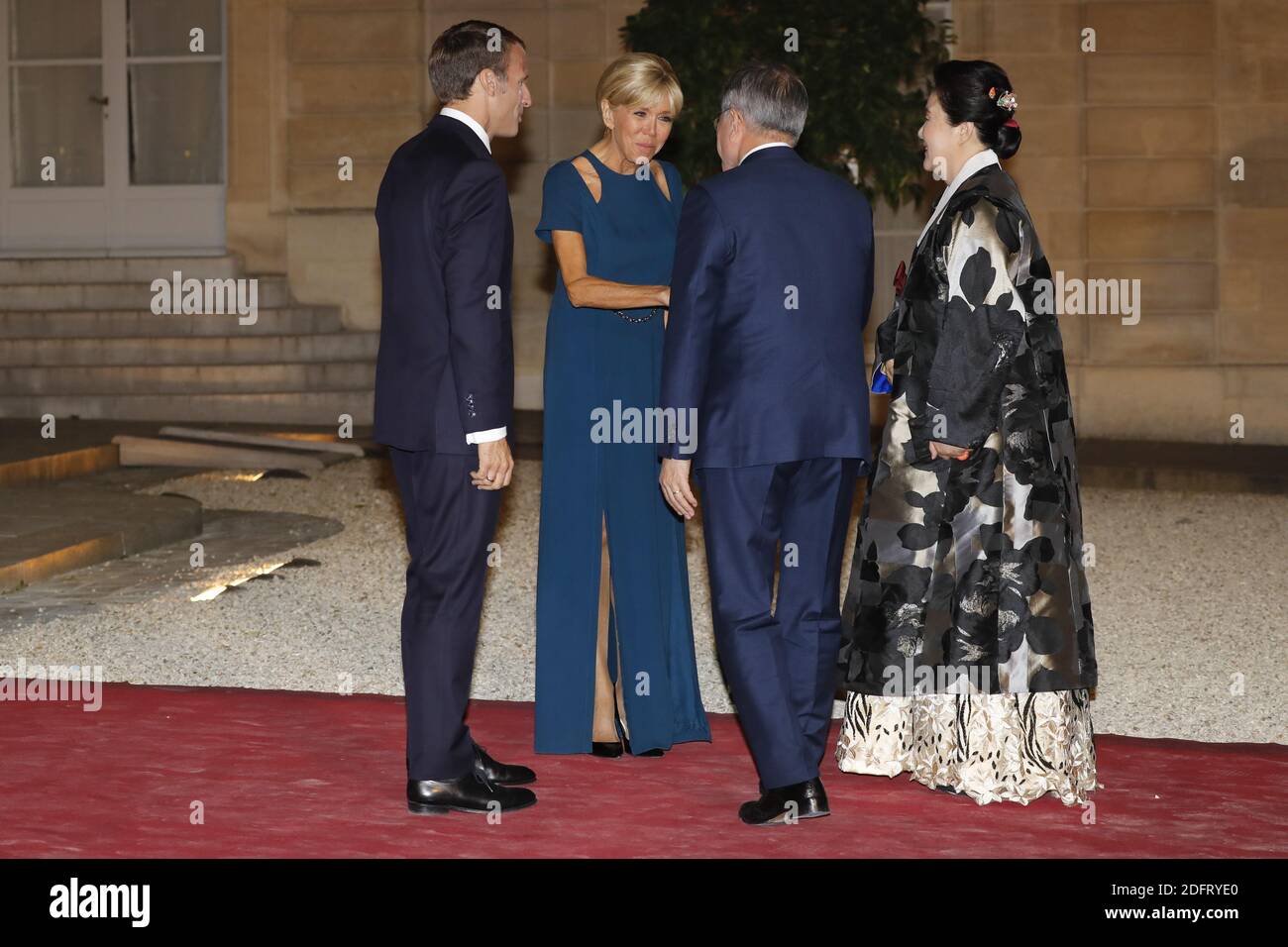 French President Emmanuel Macron and his wife Brigitte Macron greets ...