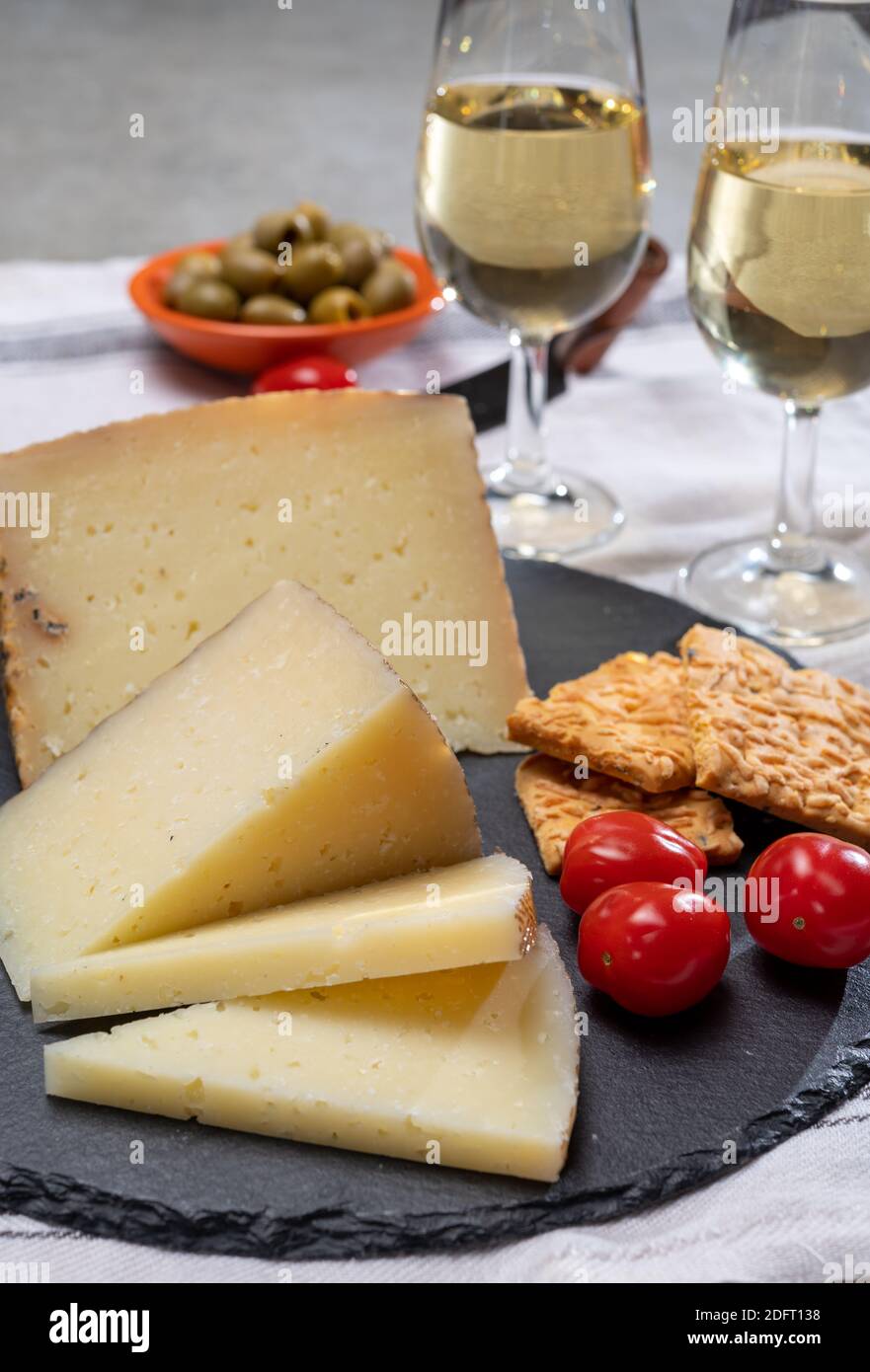 Spanish tapas, manchego cheese made, green olives served with glasses ...