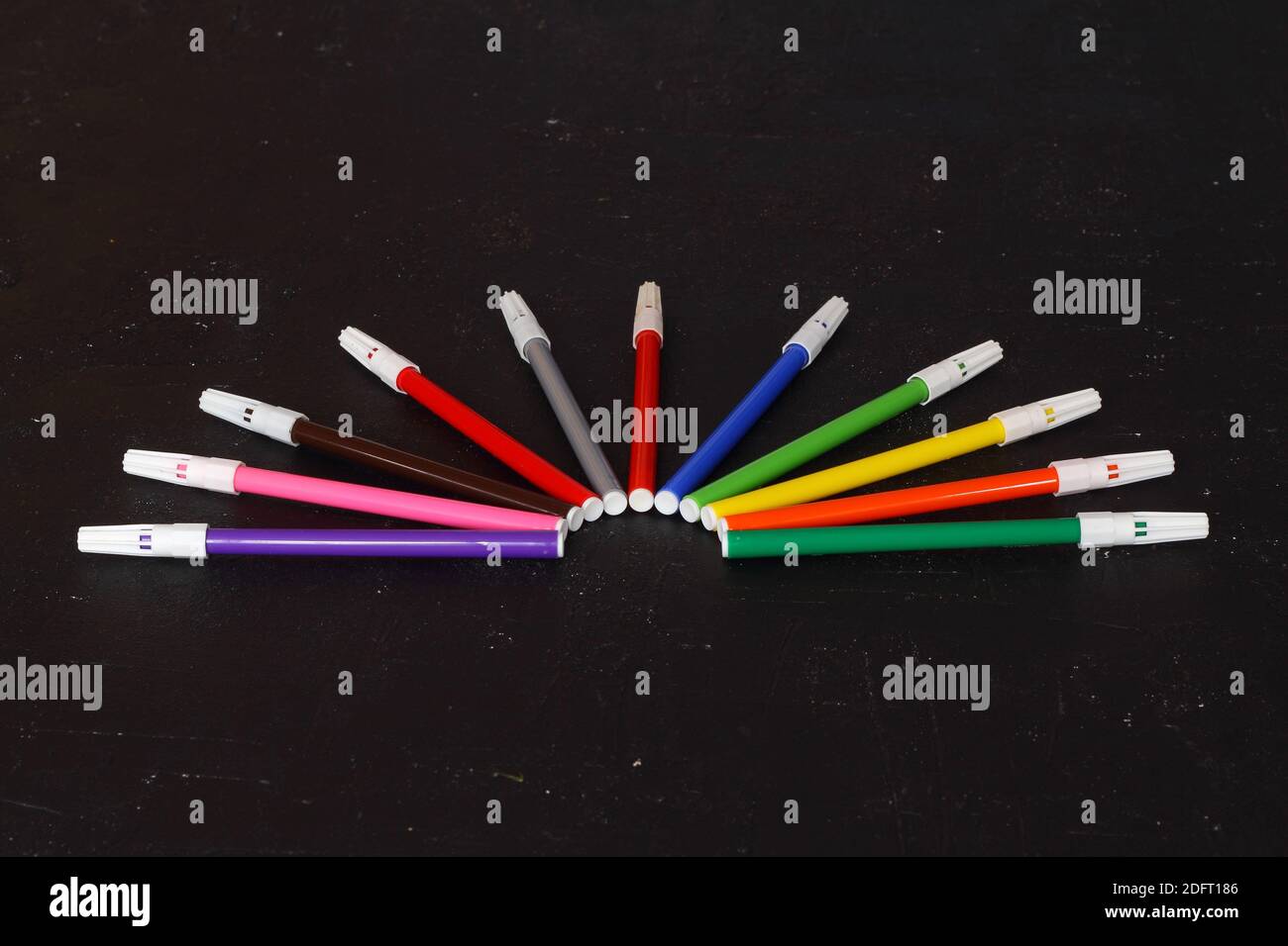 Multi-colored markers for drawing. Markers on a black isolated ...
