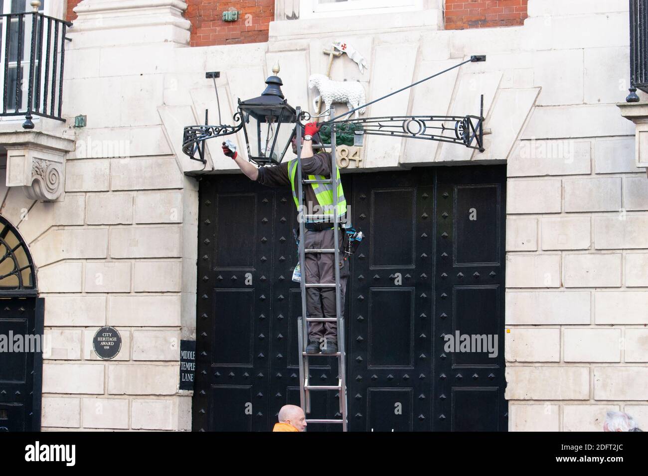 Lamplighter cleans gas lamp in Middle Temple Lane, London, UK Stock ...