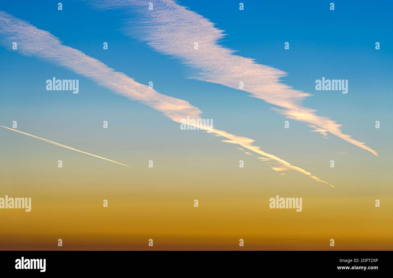 orange yellow blue sunset sunrise with clouds lines Stock Photo - Alamy