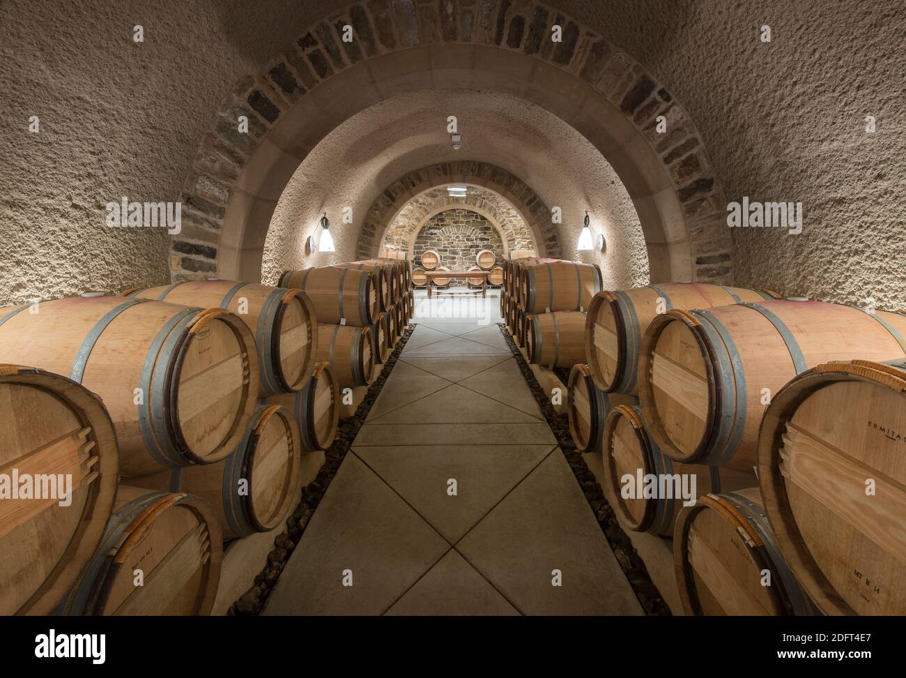 Wine is stored in wooden barrels to age and ferment in an underground ...