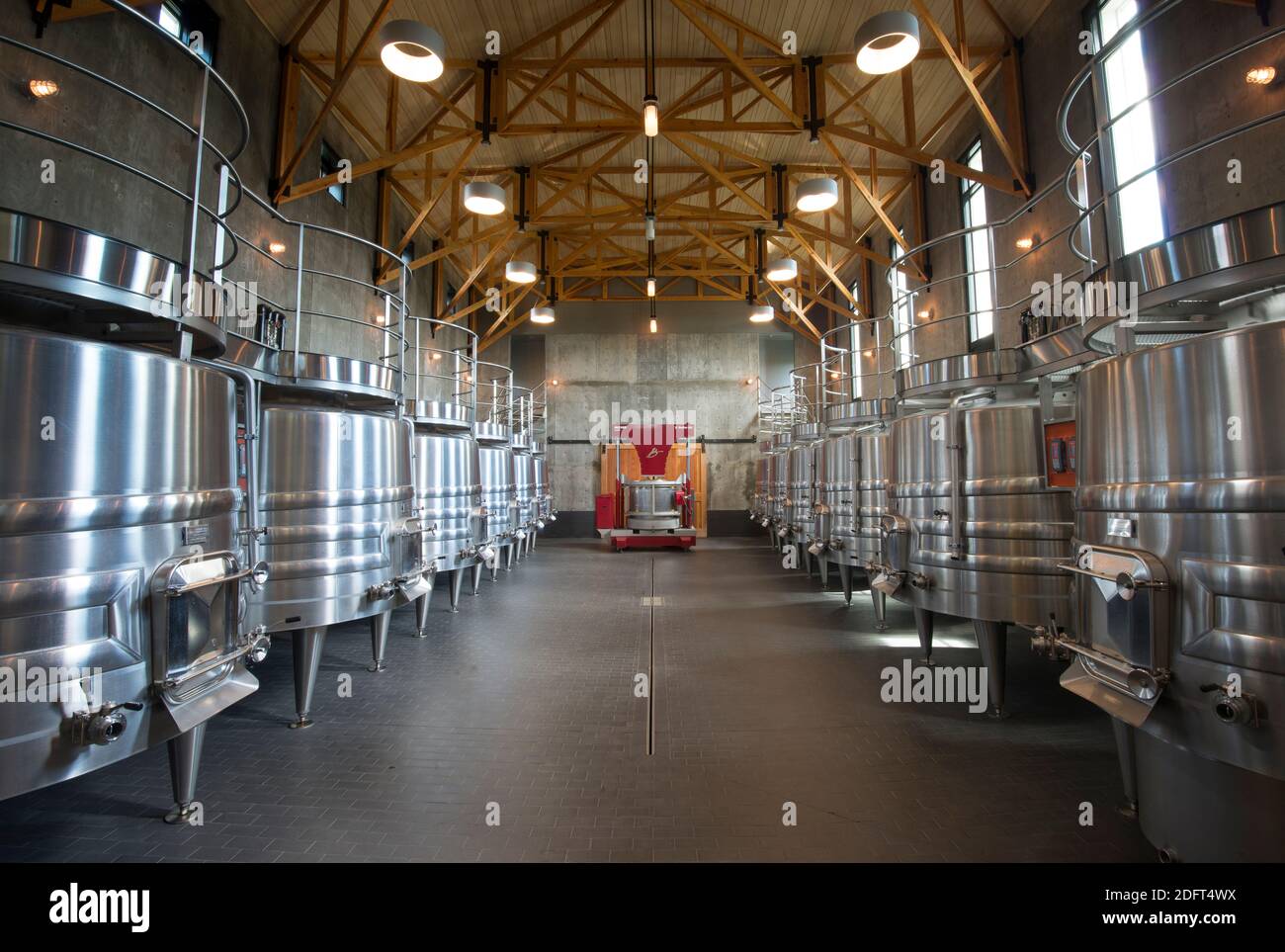 A row of wine fermenters used in wine production inside a winery Stock ...