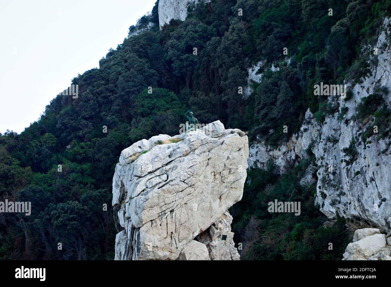 Statue of a man on a rock waving to passing boats, near the Marina ...