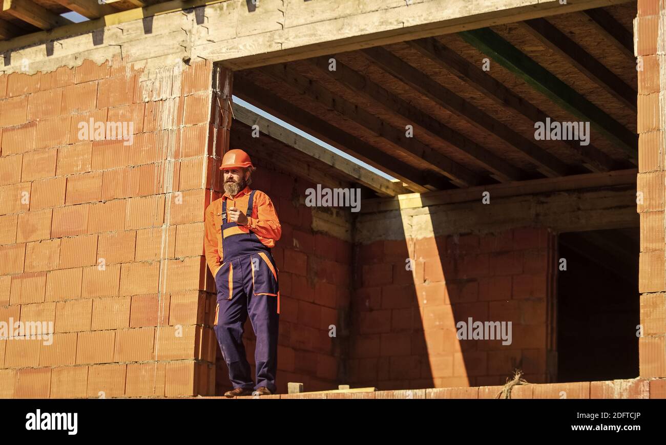 Well done. Repairman tired builder relaxing at construction site ...