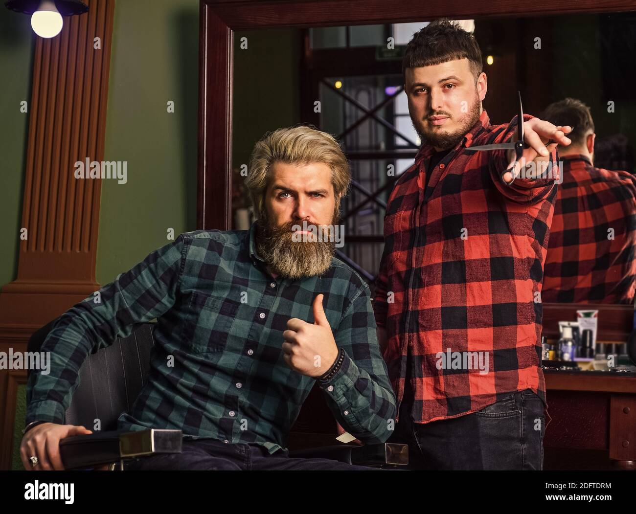 master barber does the hairstyle and styling with dryer. Concept ...