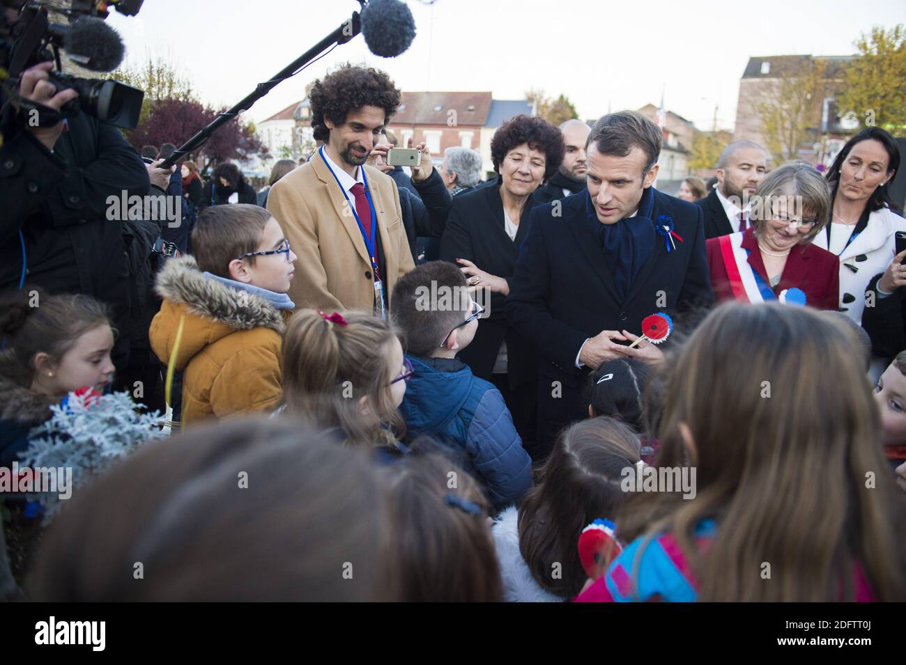 French President Emmanuel Macron greets children as he arrives at the ...