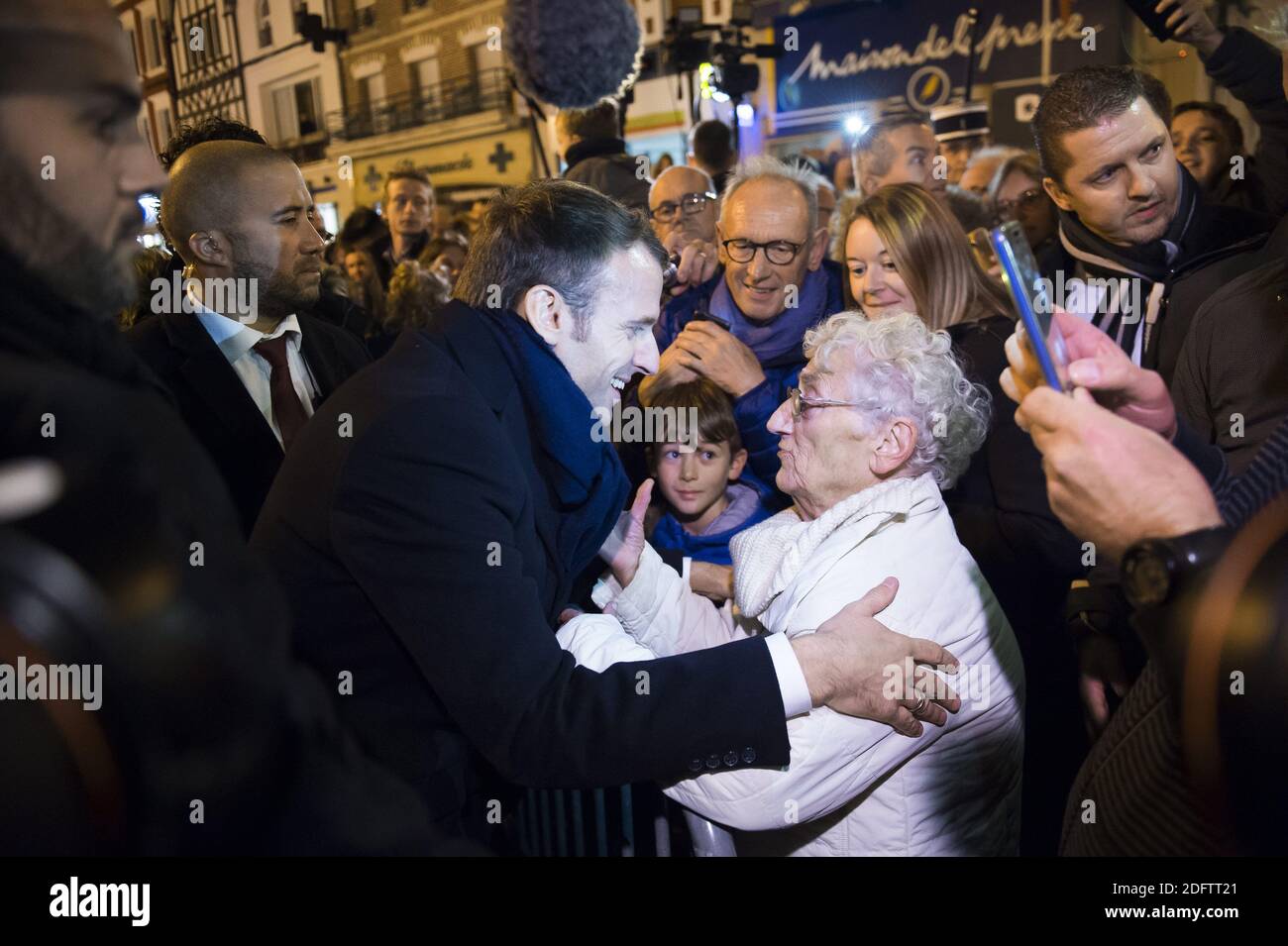 French President Emmanuel Macron shakes hands with people in the crowd ...