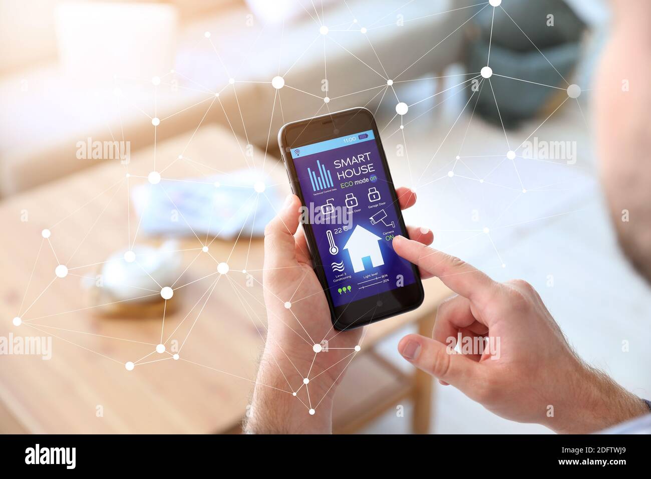 Man using application of smart home automation Stock Photo - Alamy