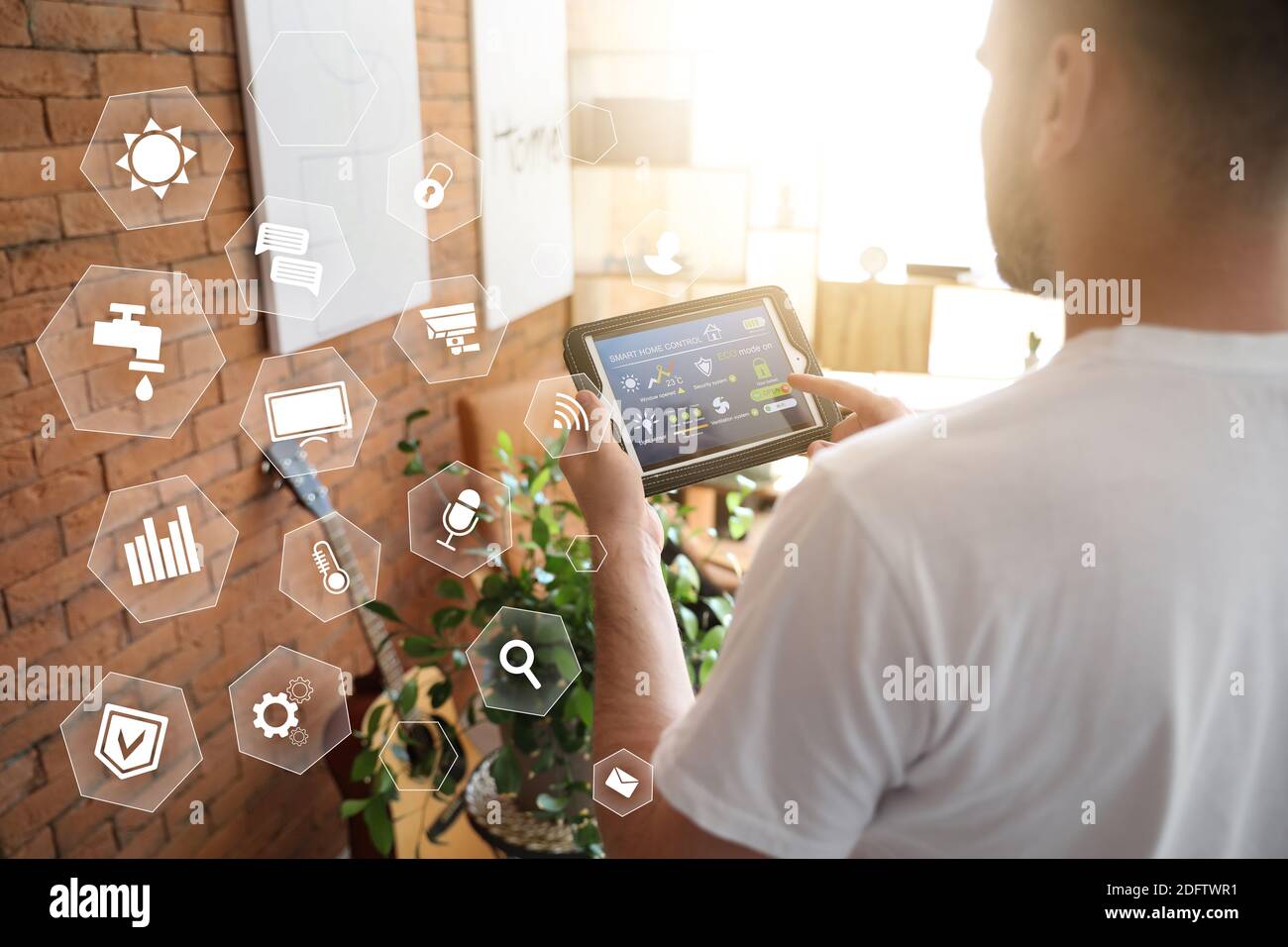 Man using application of smart home automation Stock Photo - Alamy