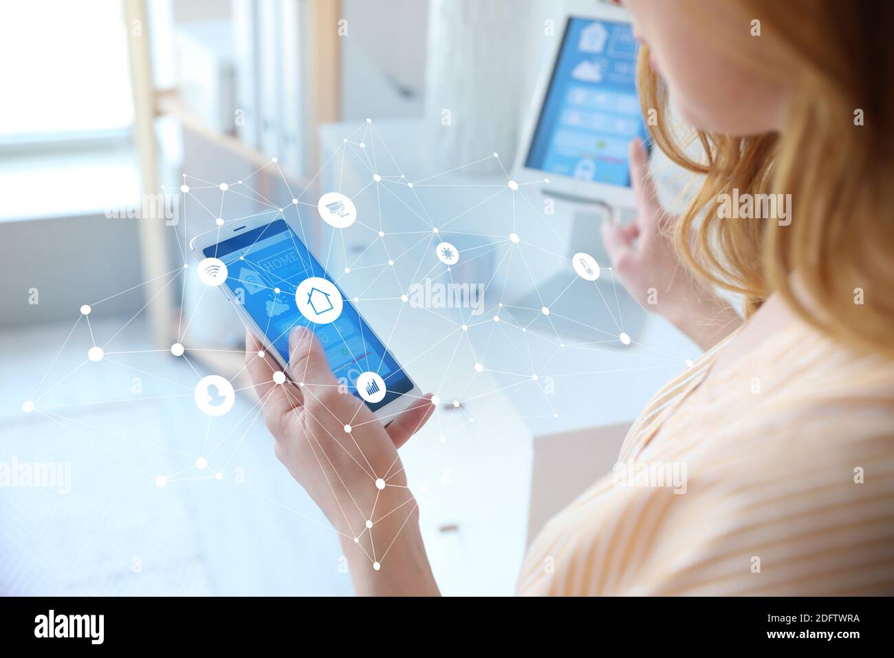 Woman using application of smart home automation Stock Photo - Alamy