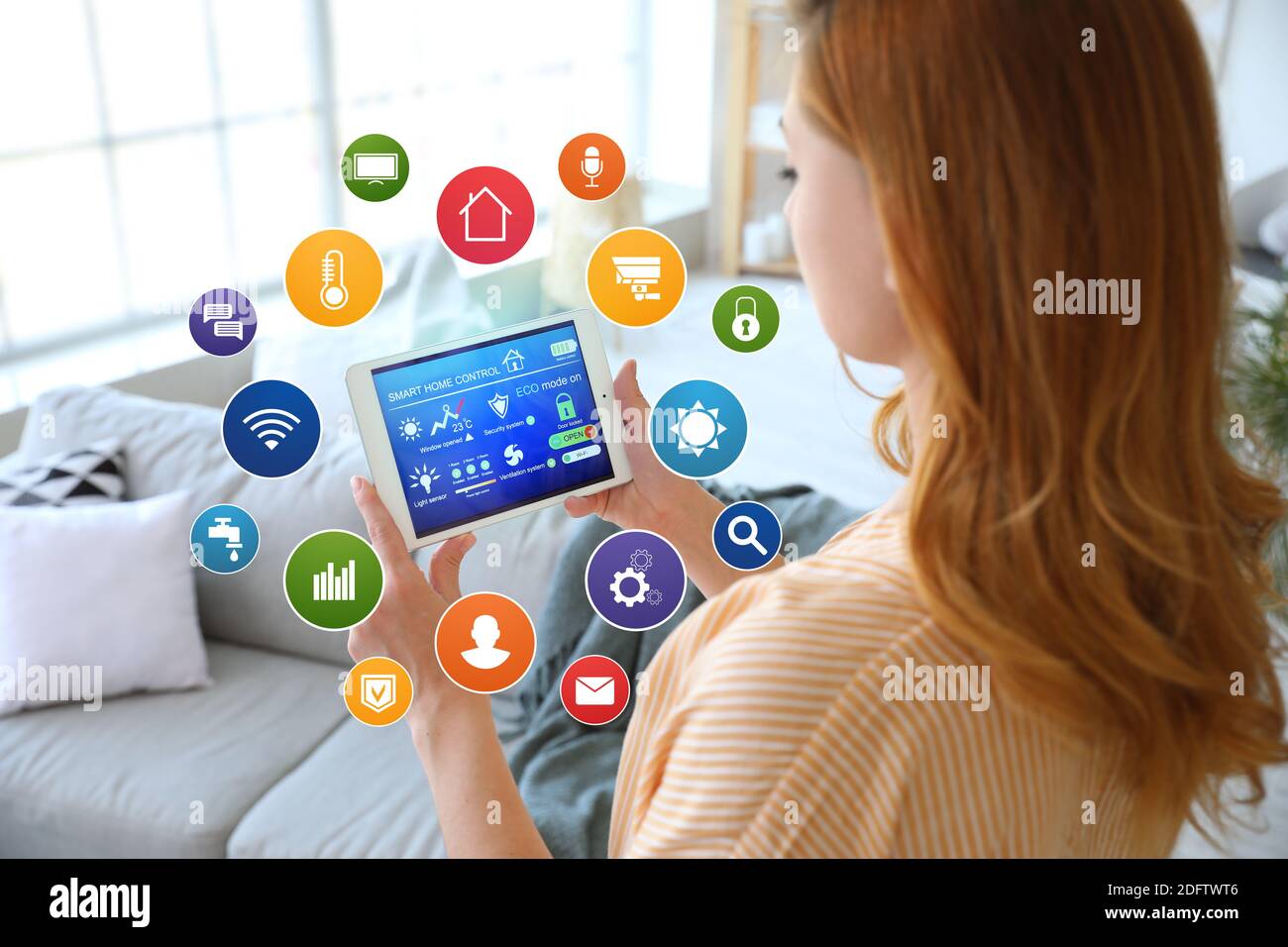 Woman using application of smart home automation Stock Photo - Alamy