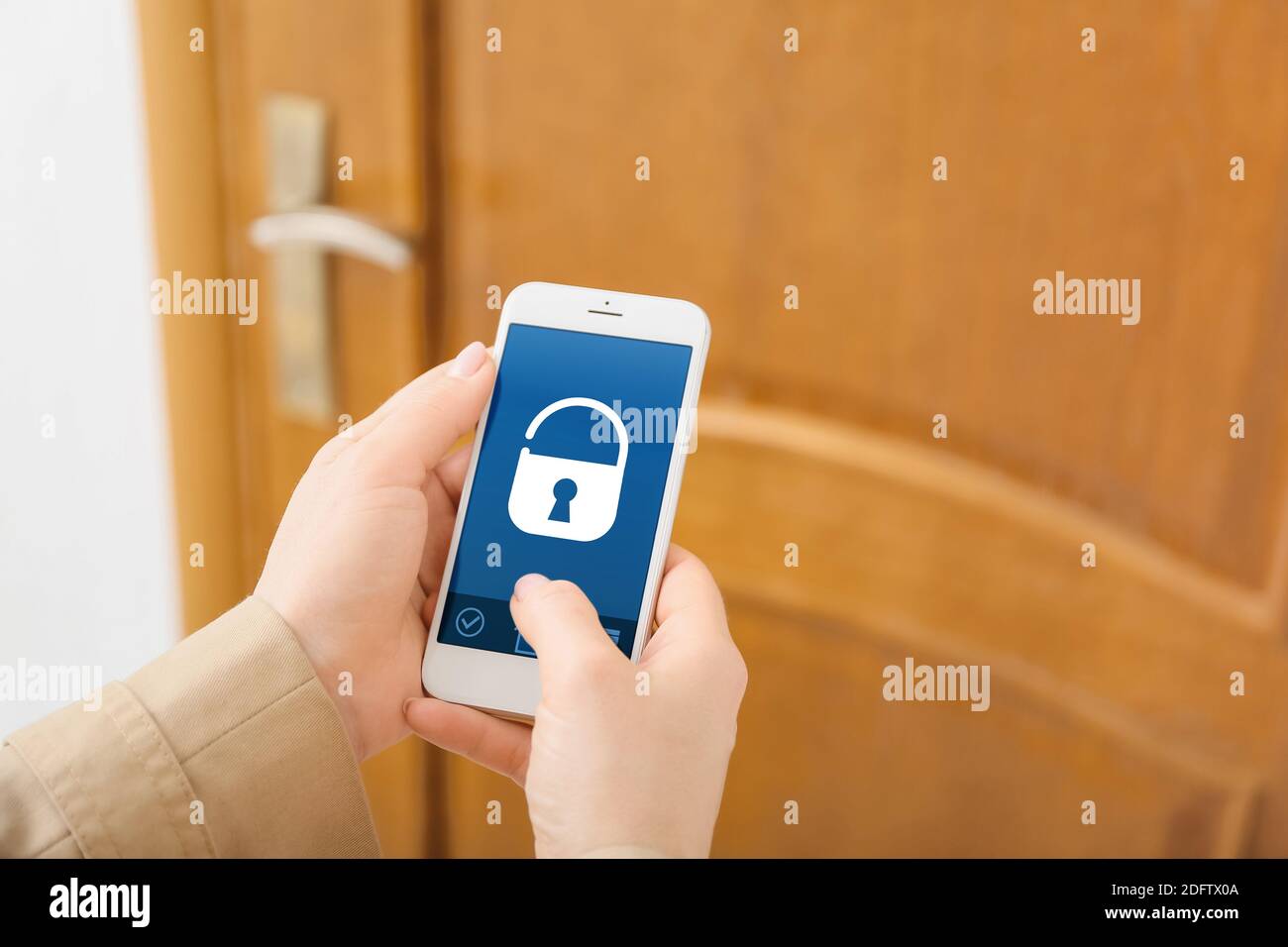 Woman using mobile phone to open door Stock Photo - Alamy
