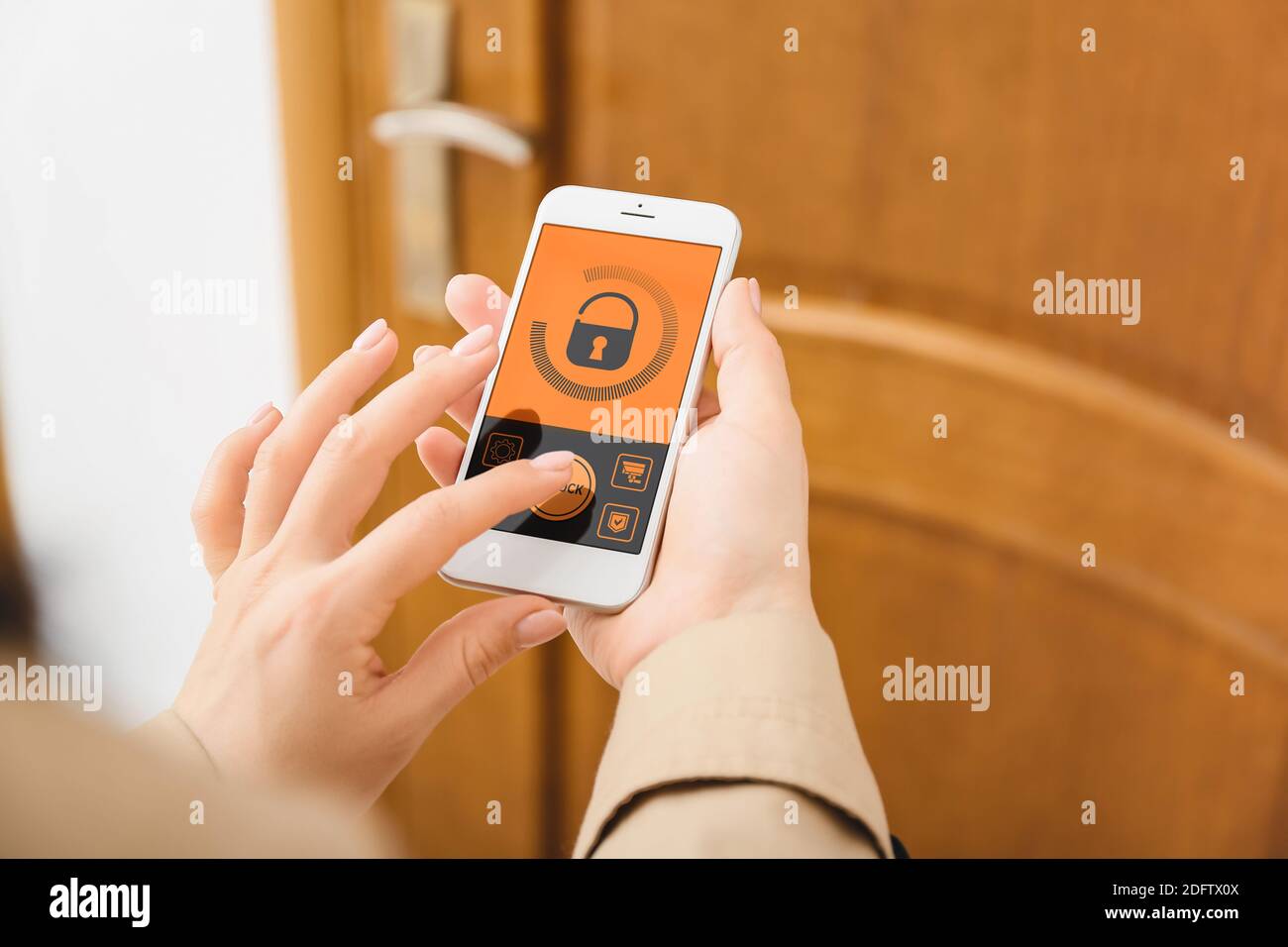Woman using mobile phone to open door Stock Photo - Alamy