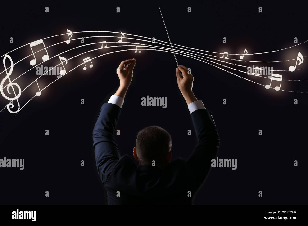 Male conductor and note signs on dark background Stock Photo - Alamy
