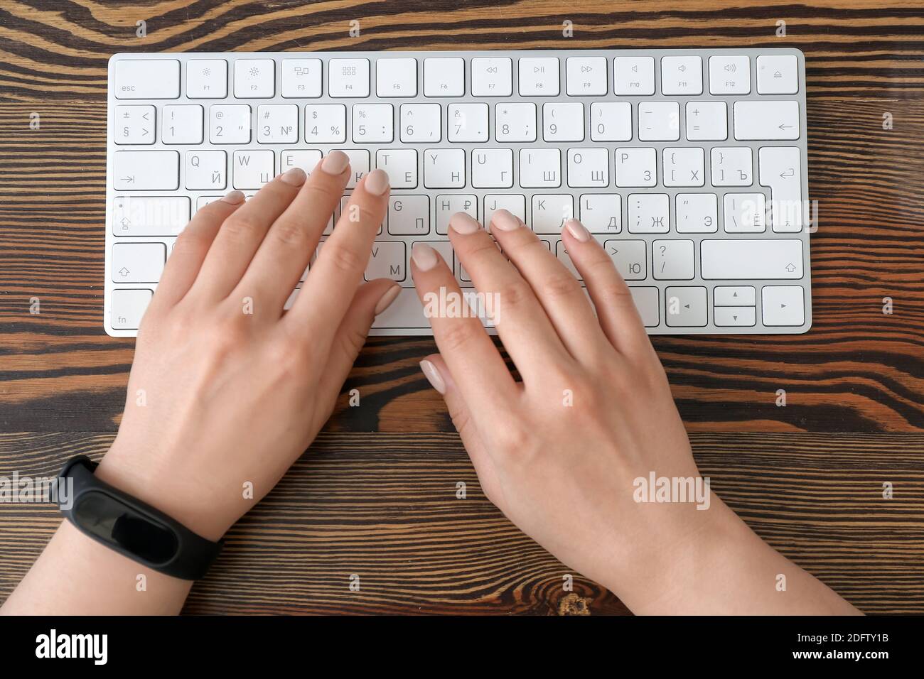Woman typing at workplace in office, top view Stock Photo - Alamy