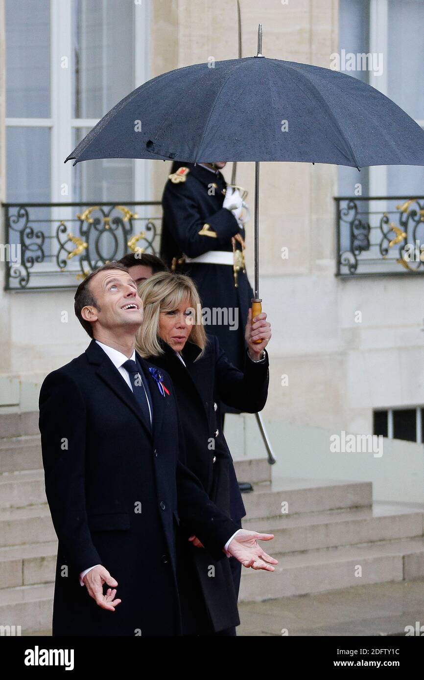 French President Emmanuel Macron and his wife Brigitte Macron welcome ...