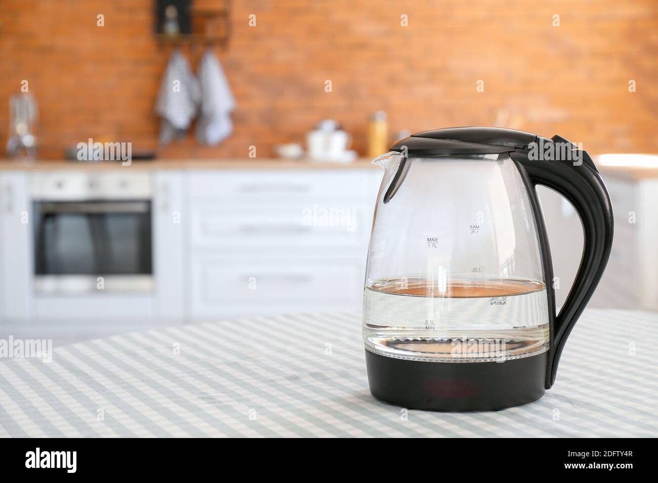 Electric kettle with water in kitchen Stock Photo - Alamy