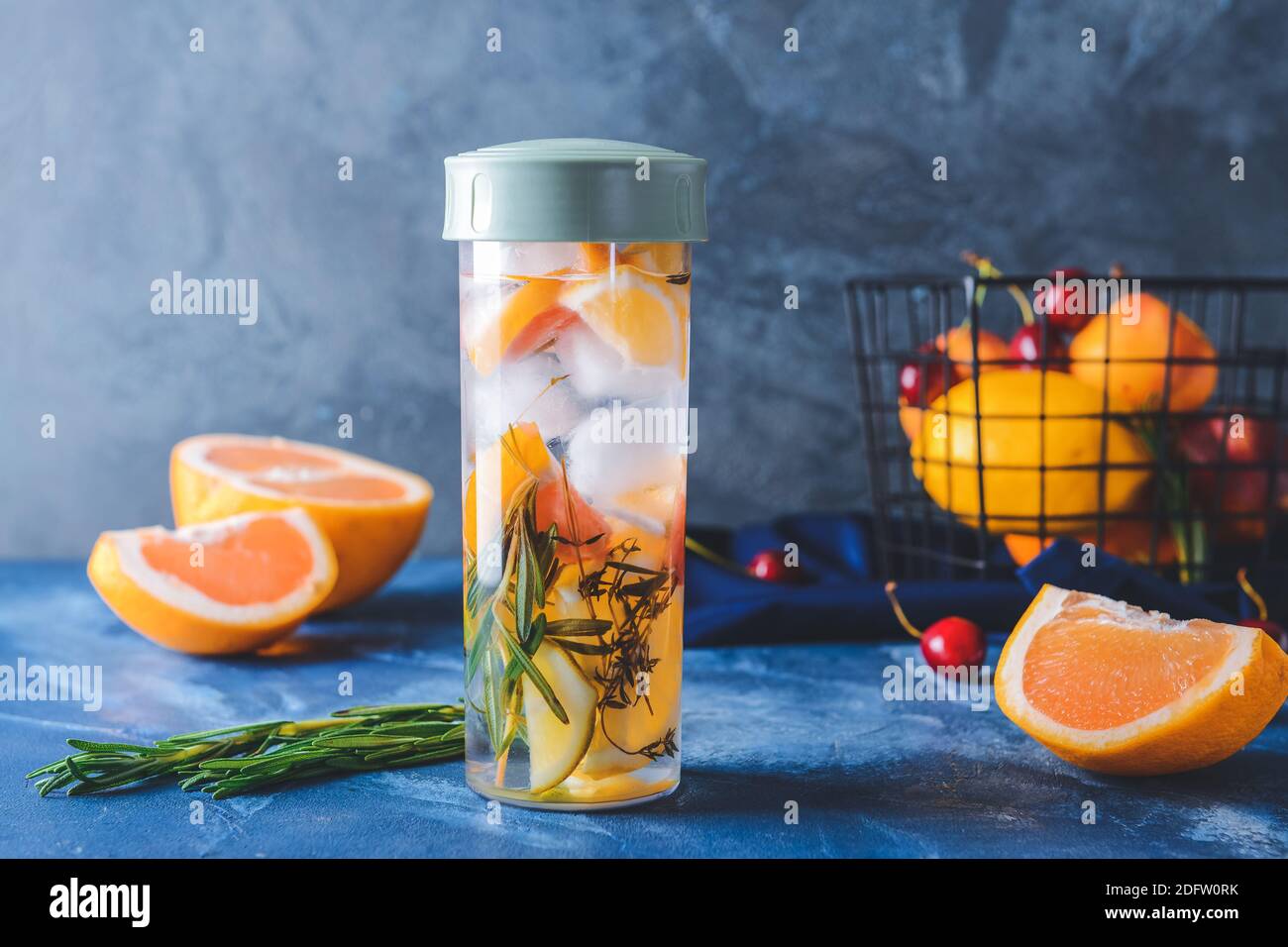 Bottle of herbal infused water with citruses on color table Stock Photo ...
