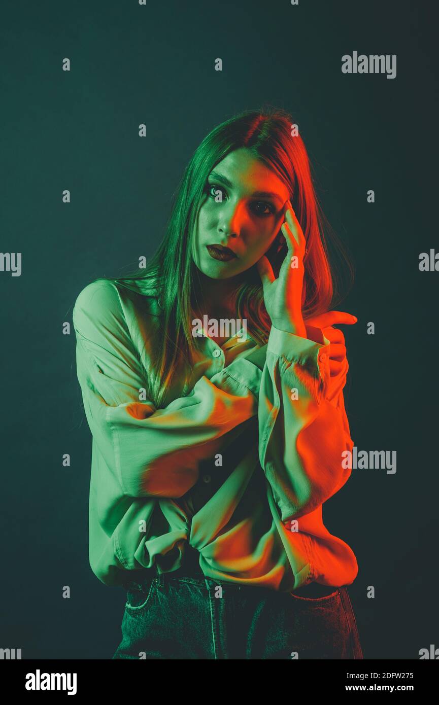 Creative portrait of a beautiful female model close-up. orange and ...