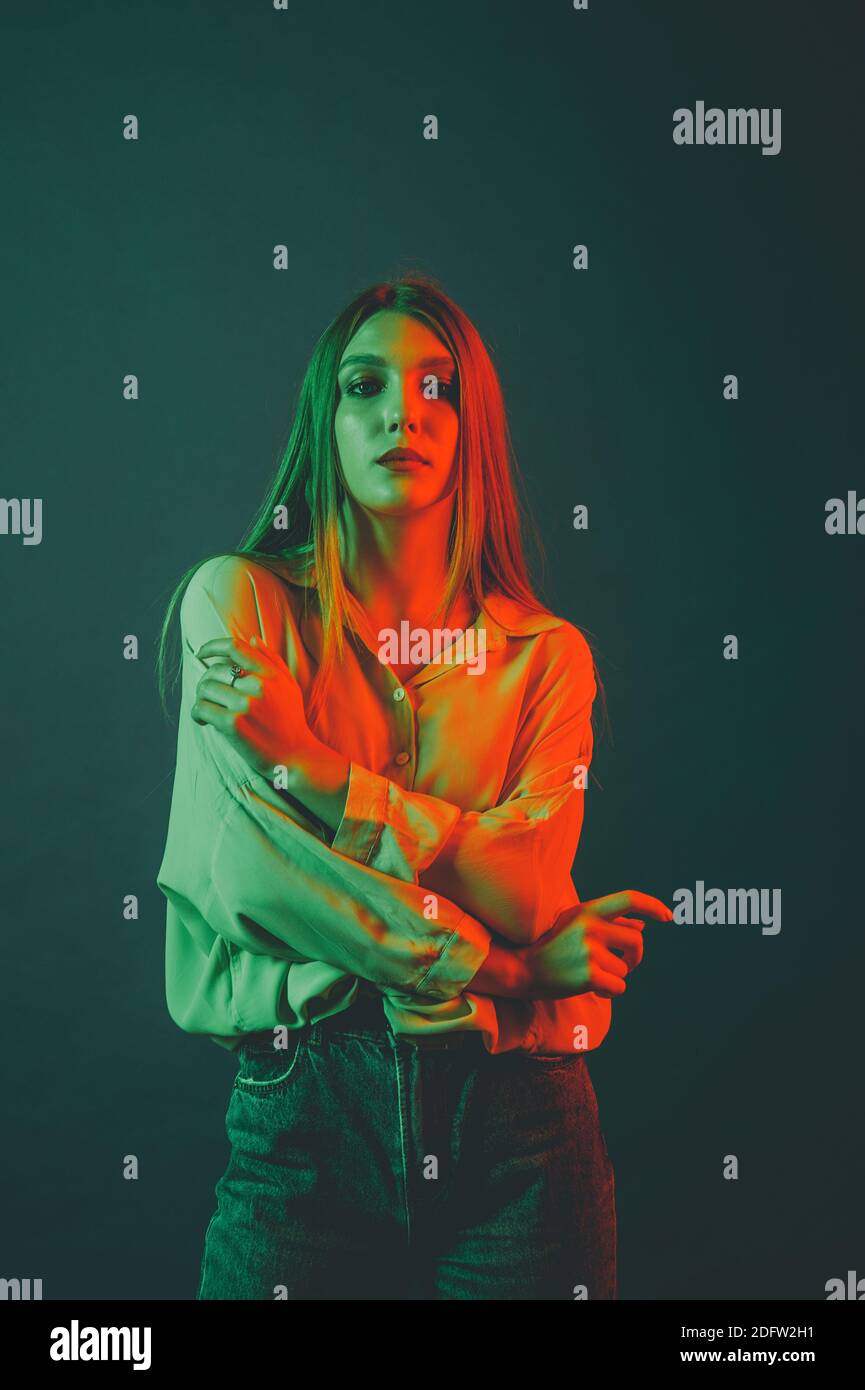 Creative portrait of a beautiful female model close-up. orange and ...