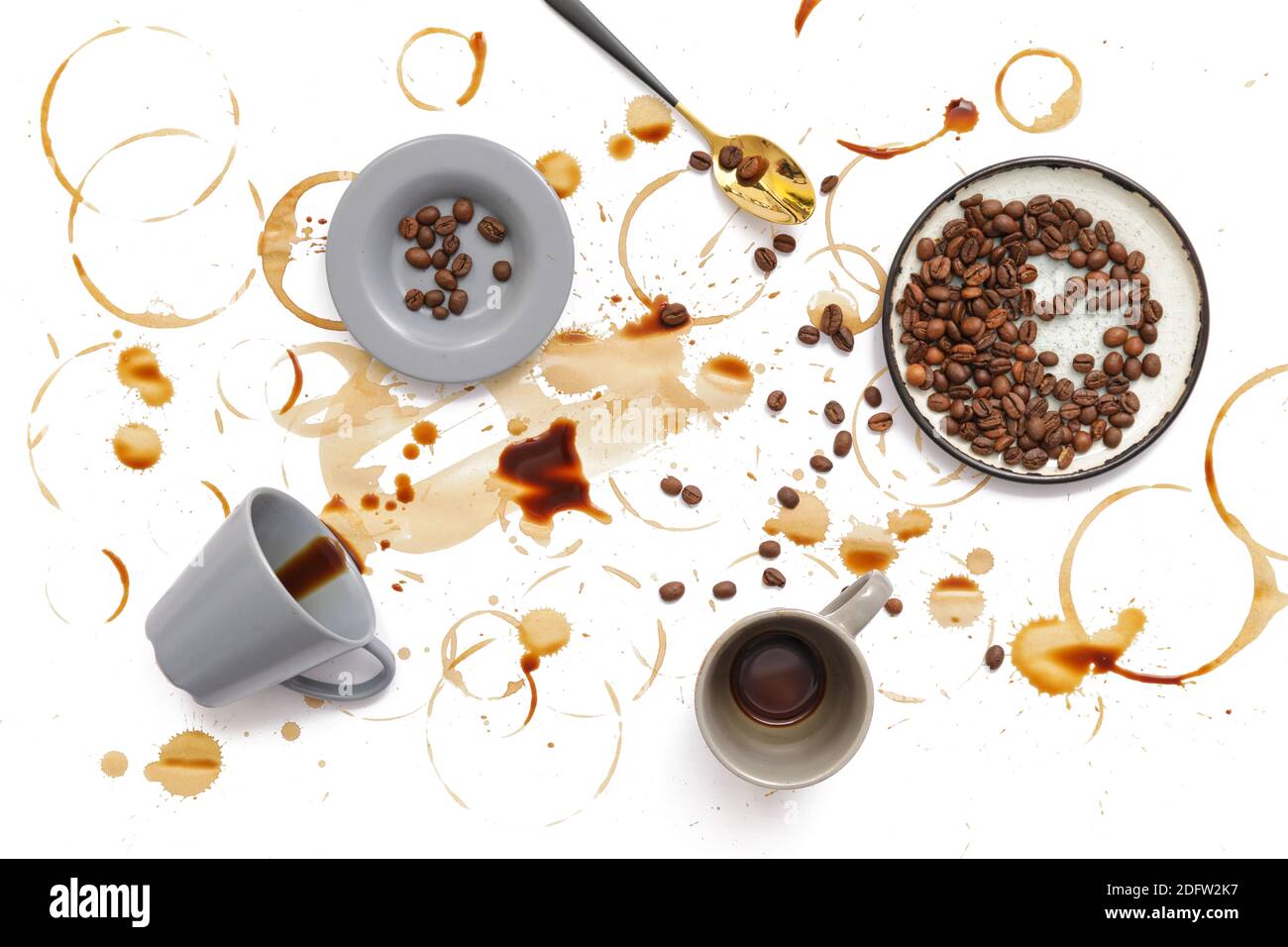 Overturned cup and spilled coffee on white background Stock Photo - Alamy